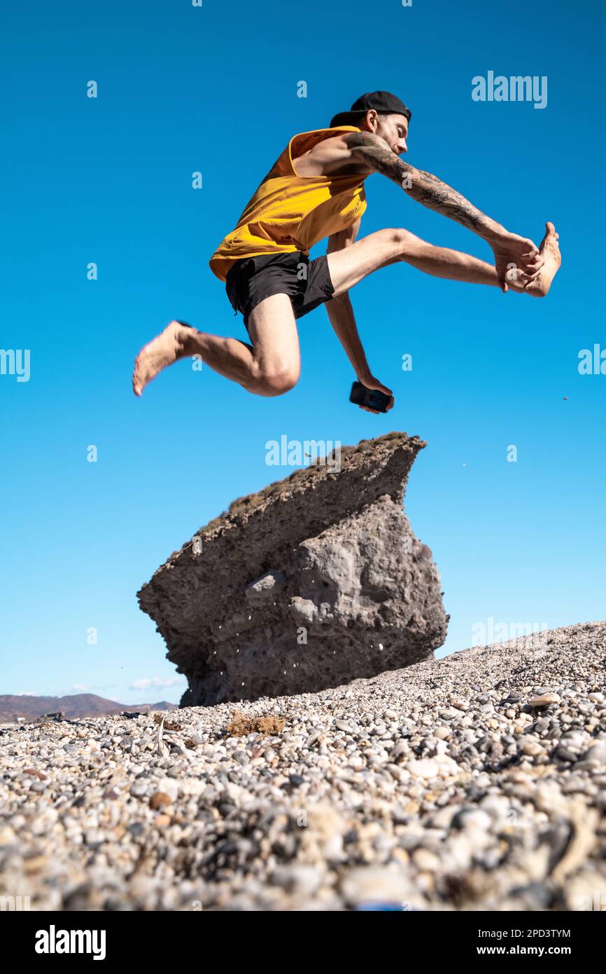 Man jumping over rocks hi-res stock photography and images - Alamy