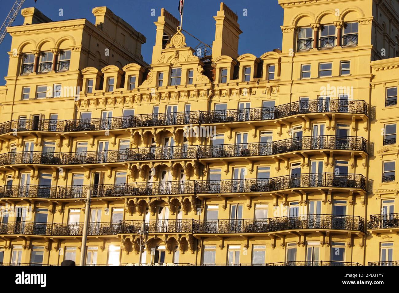 An aged hotel building with multiple balconies on the upper level Stock ...