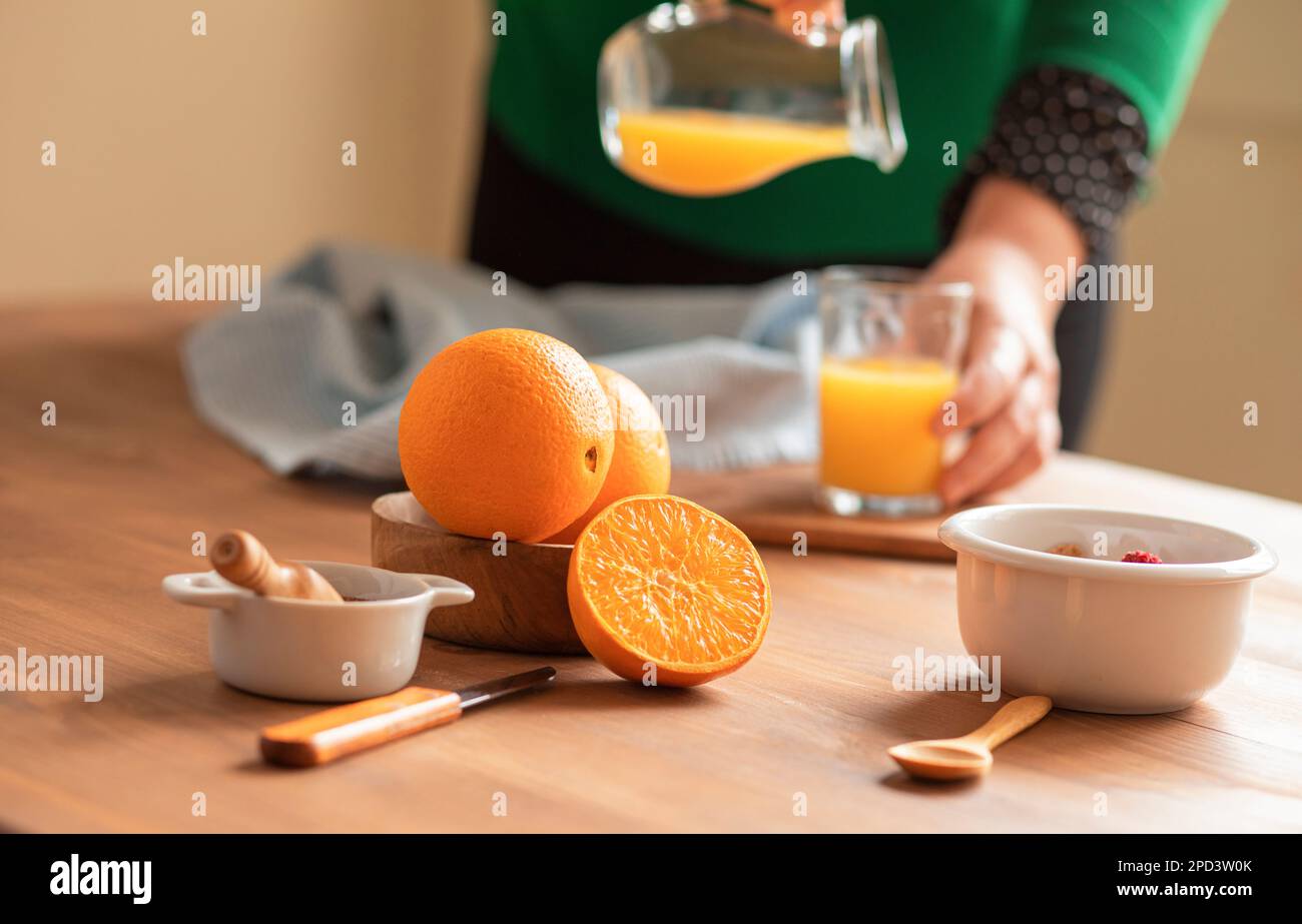 Still life of breakfast with oranges and cereals on a wooden table, and ...