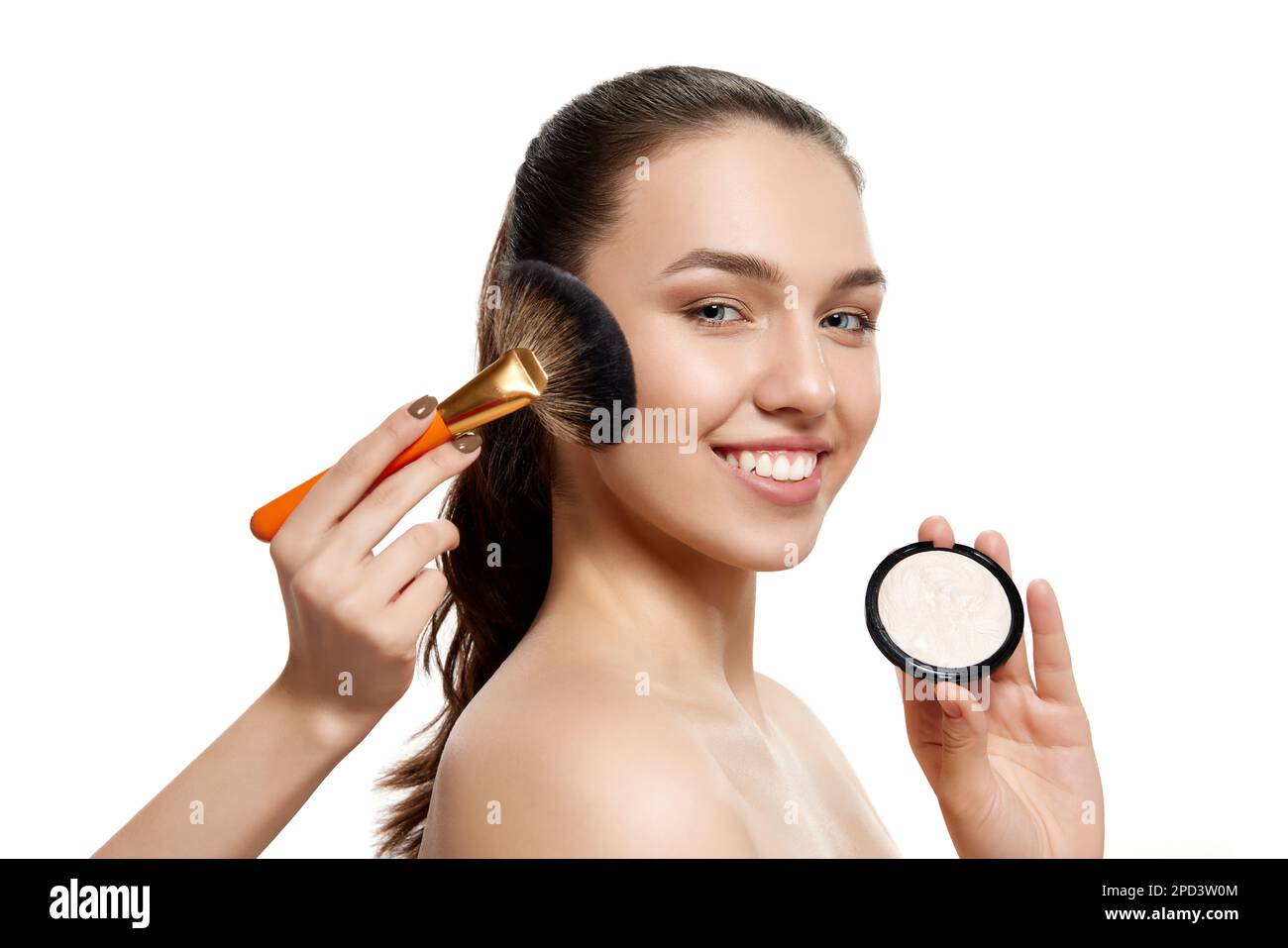 Cheerful adorable young with bared shoulders making up over white ...