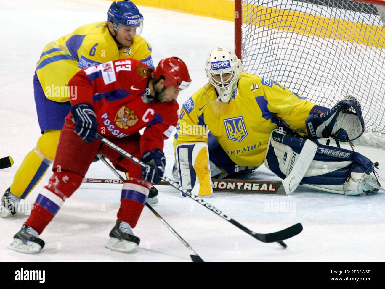 Russia's captain Maxim Sushinsky, center, tries to score against Ukraine's goalkeeper Igor ...