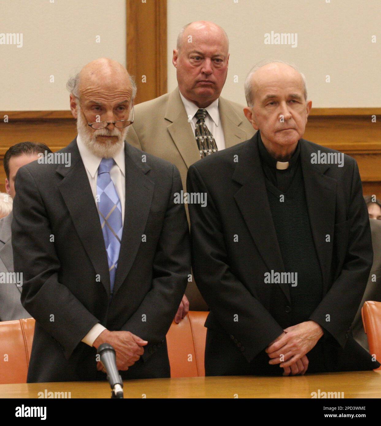 The Rev. Gerald Robinson, right, listens with his defense attorney Alan ...