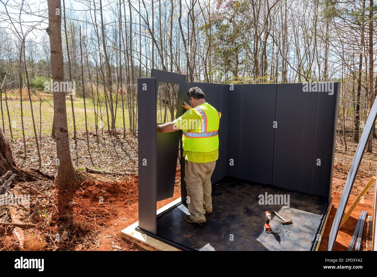 Worker to assembling together plastic shed for backyard near in home ...