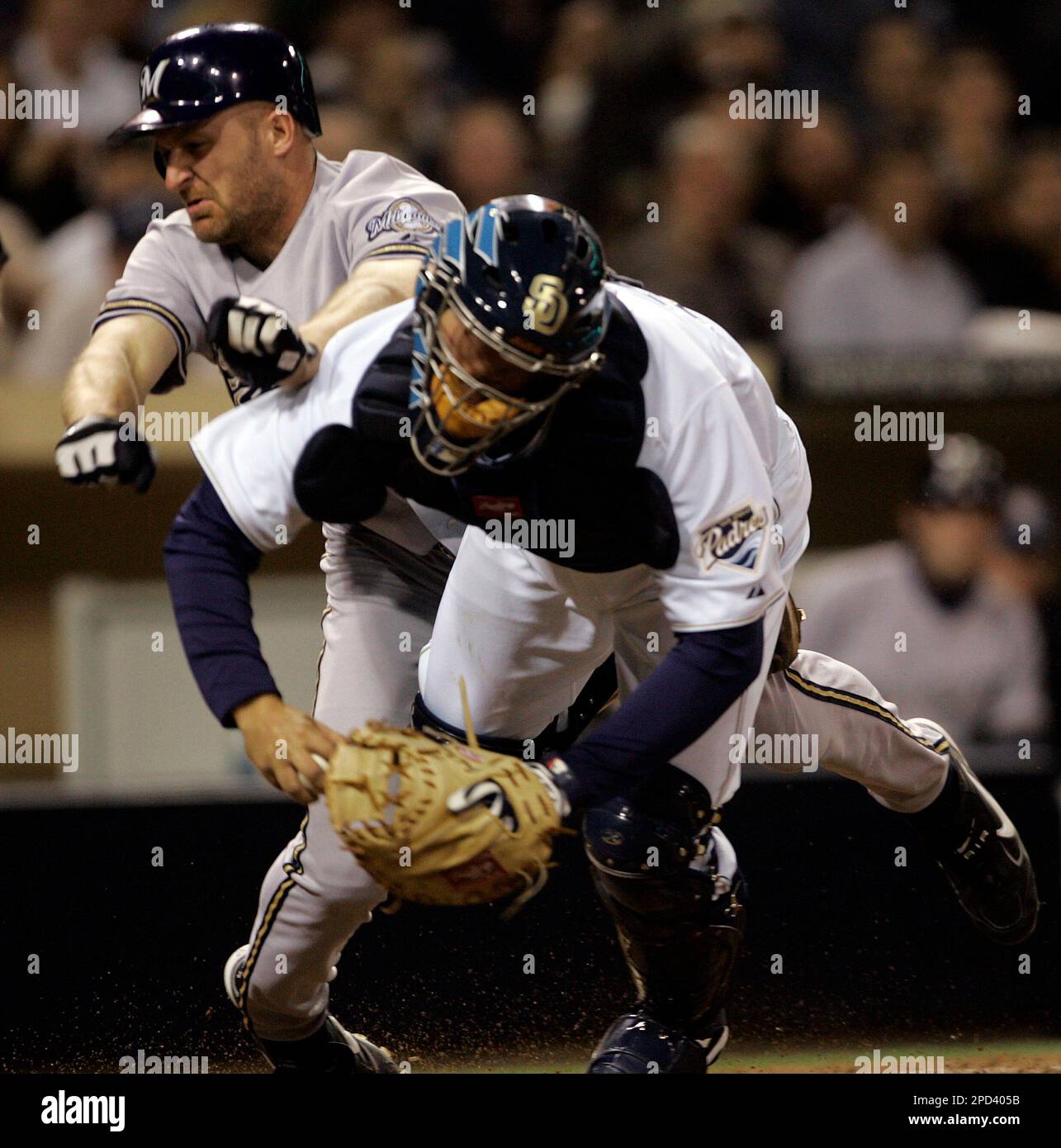 San Diego Padres catcher Josh Bard is sent flying by Corey Koskie of ...