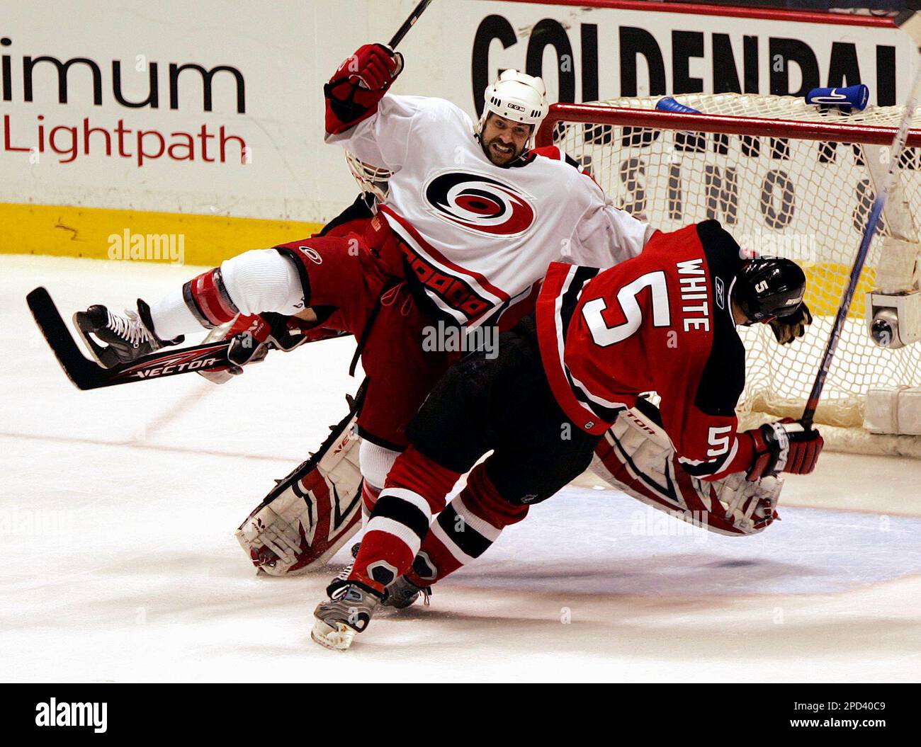 New Jersey Devils' Colin White, right, and Carolina Hurricanes' Doug ...