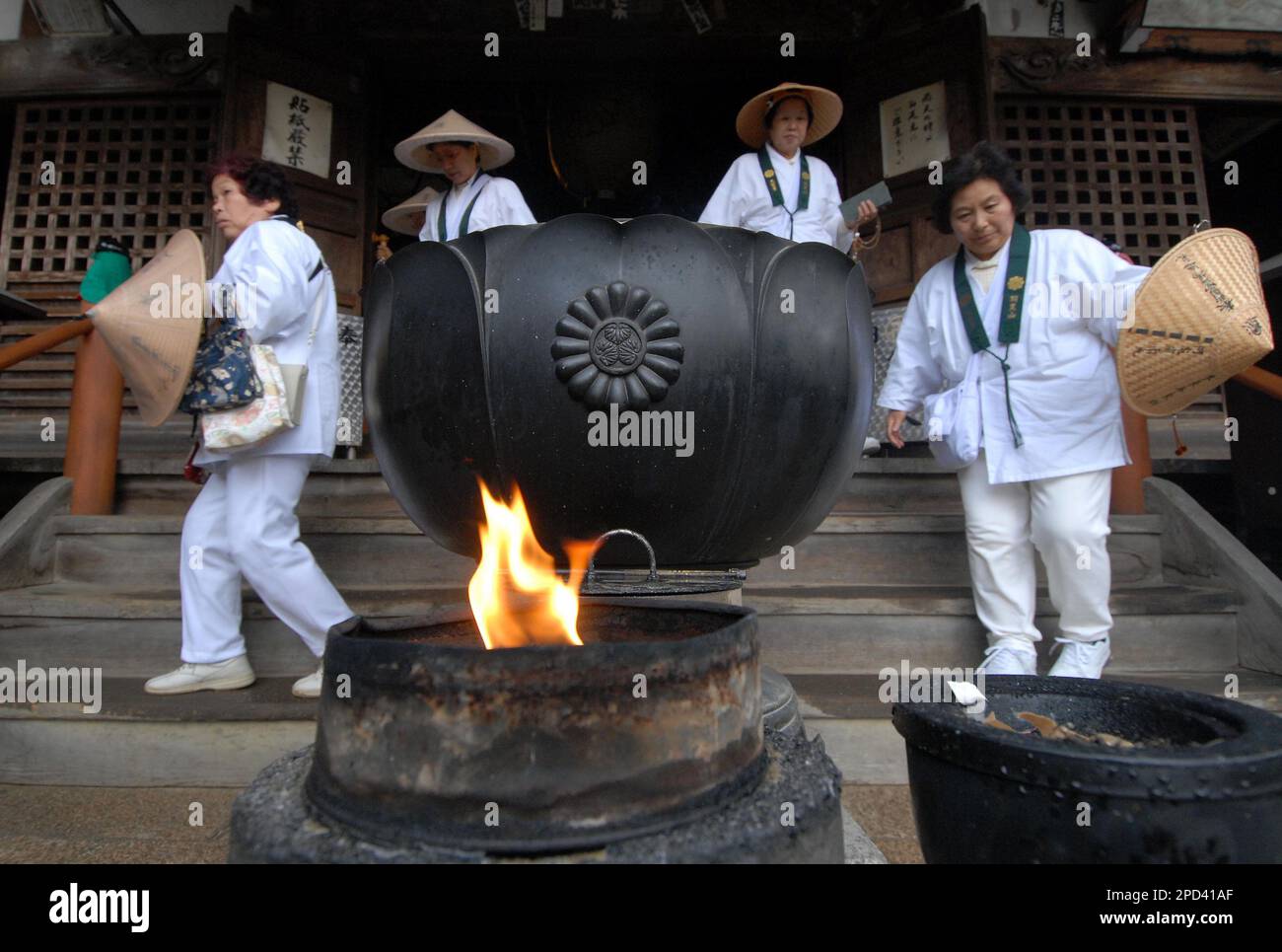 ** ADVANCE FOR FRIDAY MAY 12 ** Pilgrims in white smocks and straw hats ...