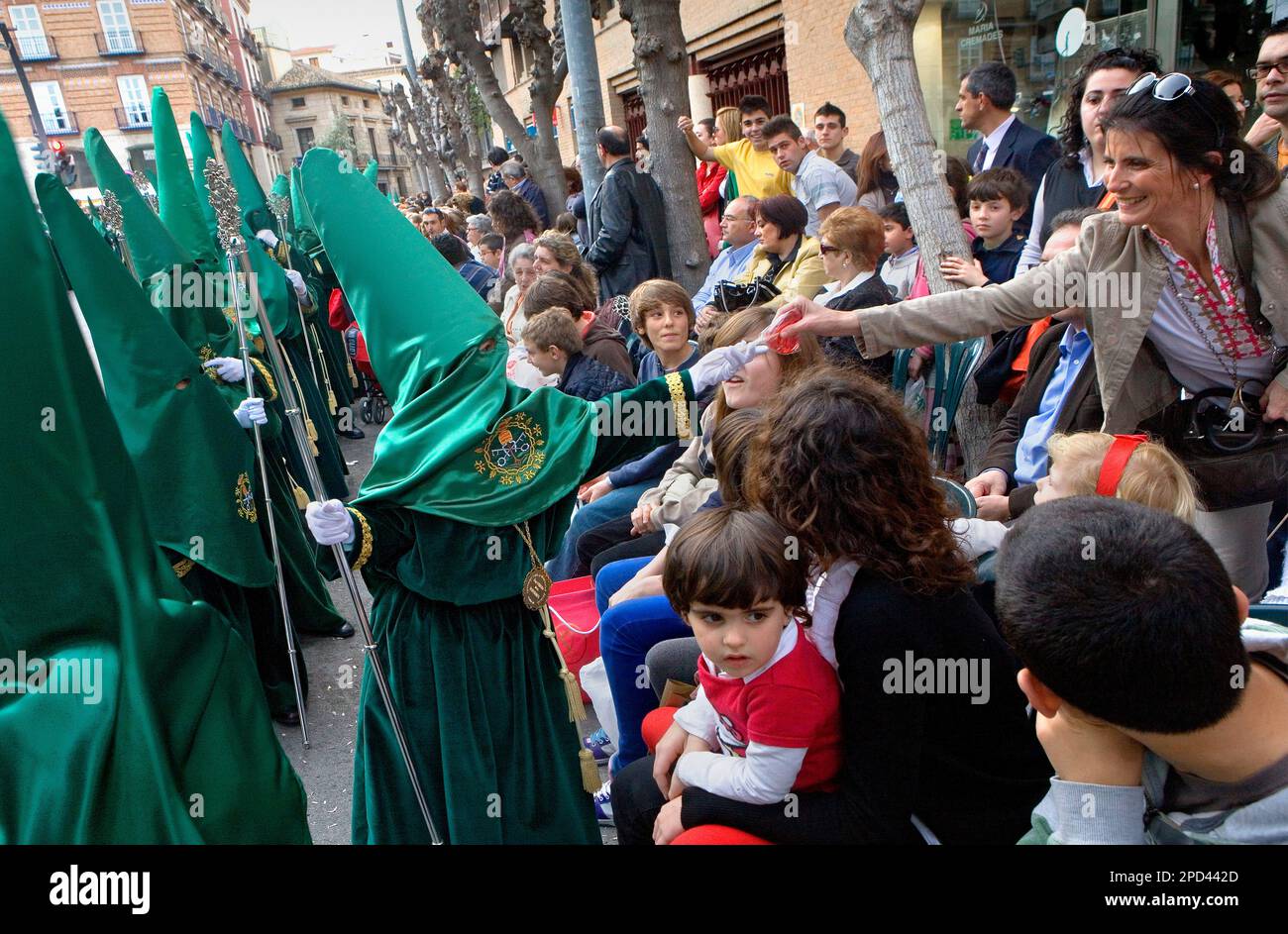 Penitent giving candy.Palm Sunday procession(Cofradia del Santisimo ...