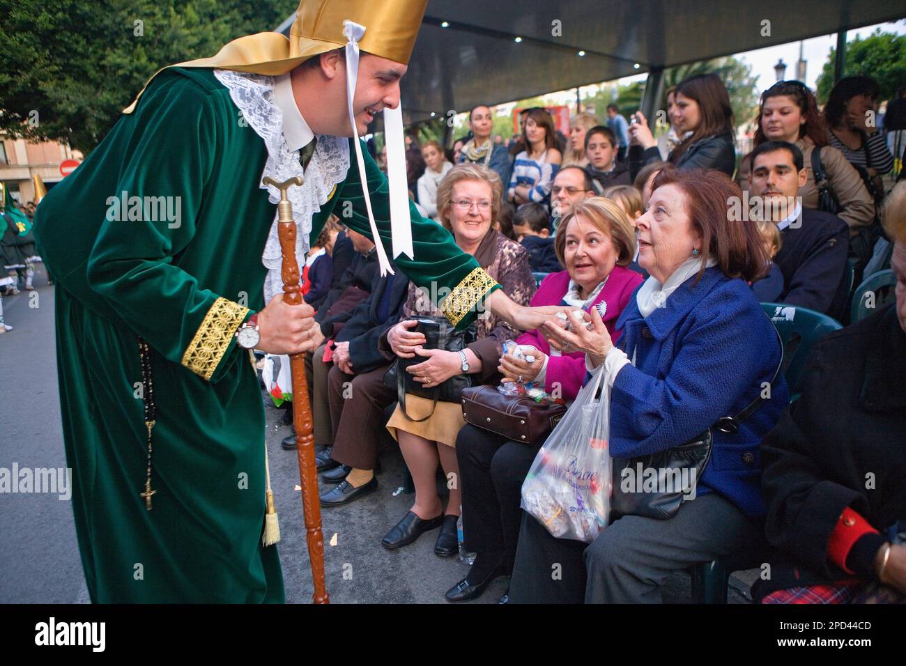 Penitent giving candy.Palm Sunday procession(Cofradia del Santisimo ...