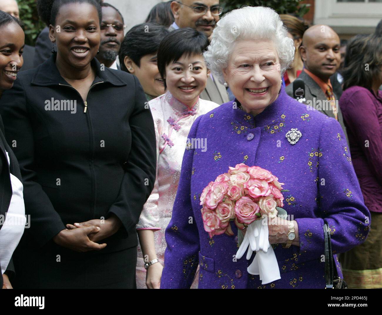 Britain's Queen Elizabeth II walks past staff from the Commonwealth ...