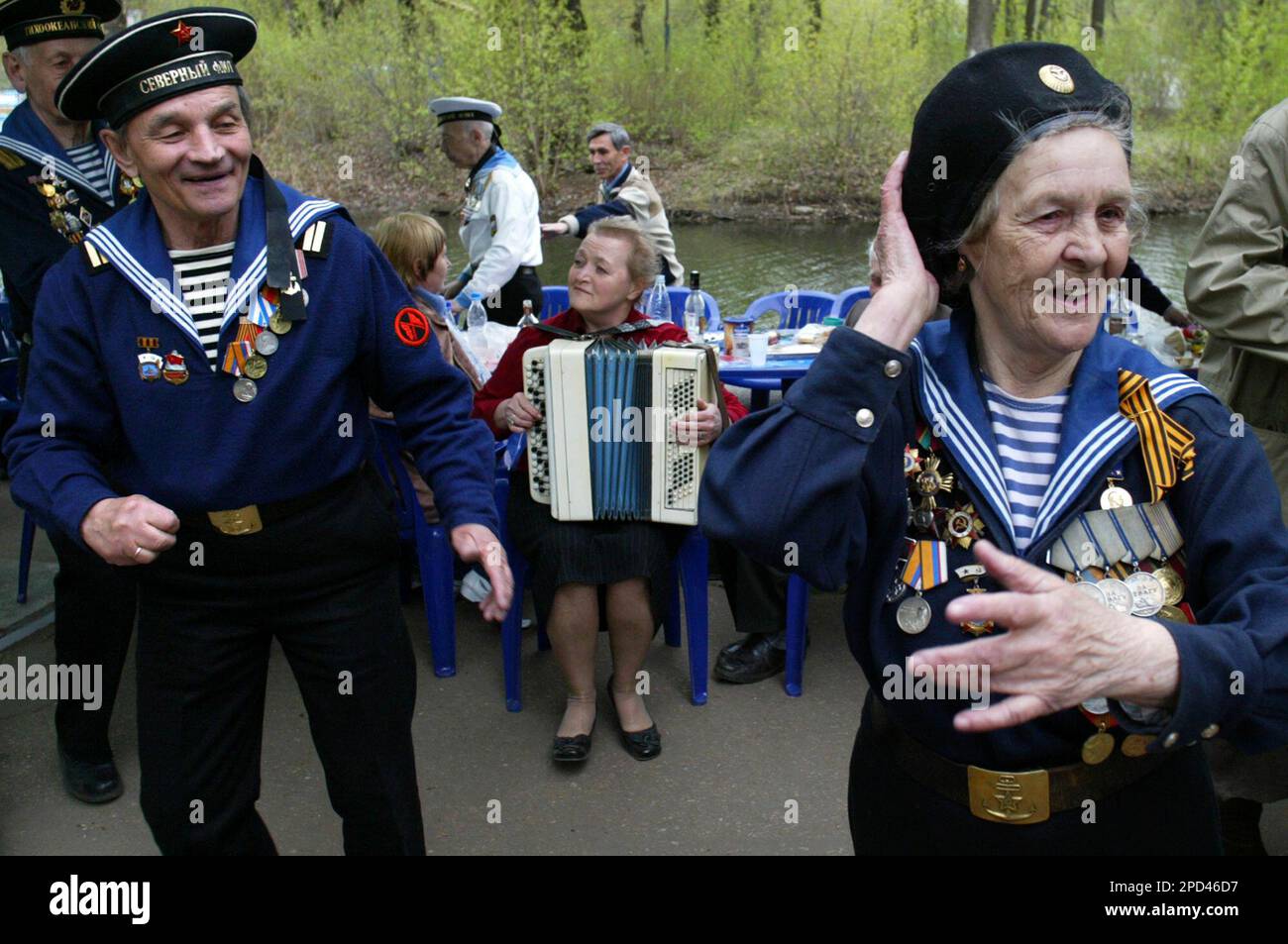 A woman, World War II veteran and former sailor, wearing three medals ...