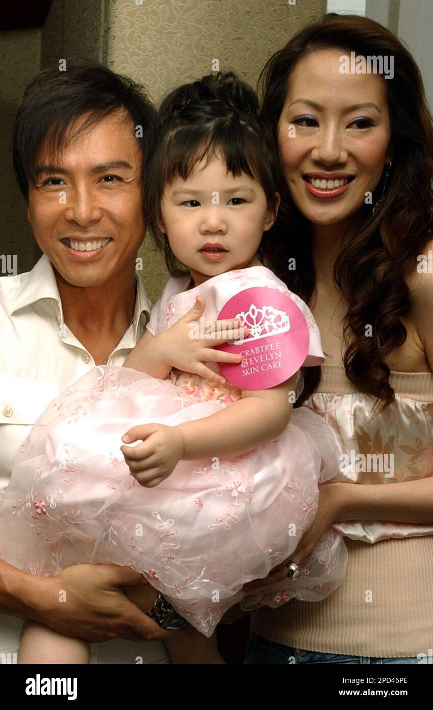 Hong Kong martial art actor Donnie Yen poses with his wife Cissy and ...