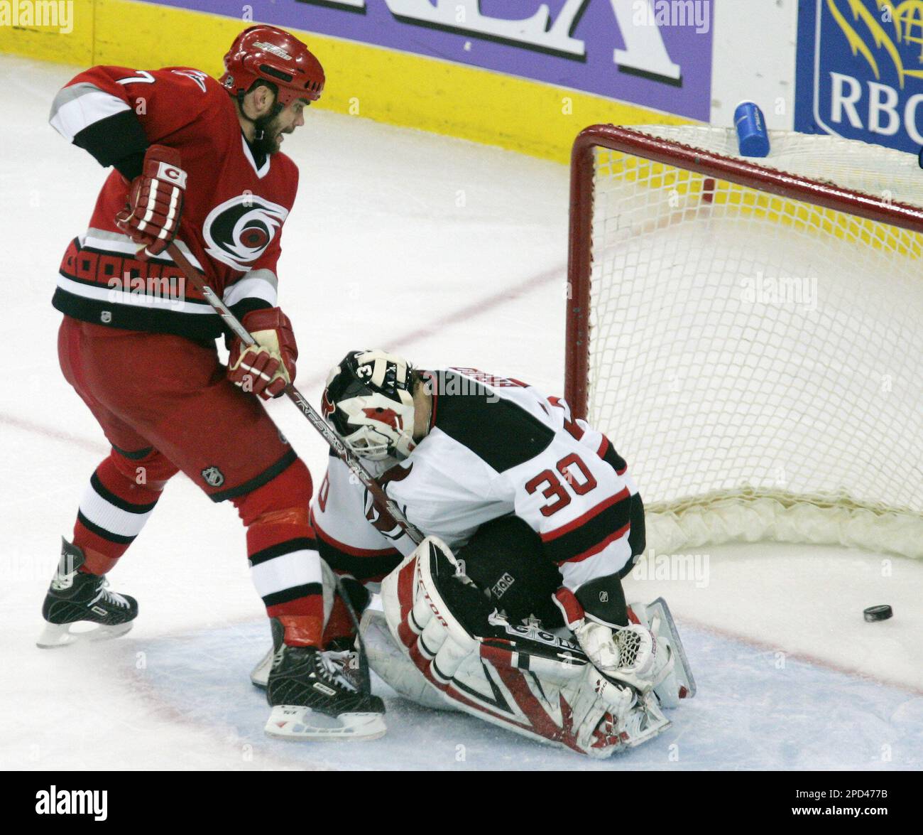 Carolina Hurricanes' Niclas Wallin, left, scores the game-winning goal ...