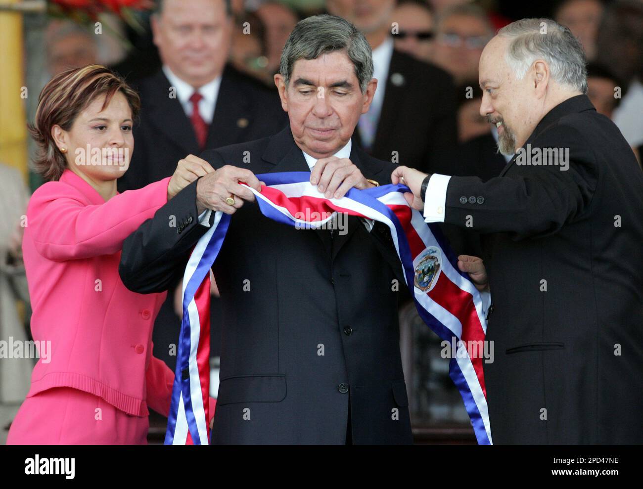 Costa Rican President Oscar Arias, left, receives the Presidential sash ...