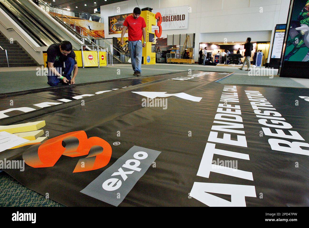 Exhibition workers Domonic Ostrom, left, and Travis Spell prepare to ...