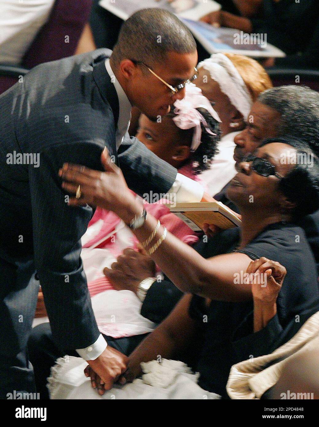Atlanta rapper T.I., whose real name is Clifford Harris, left, embraces ...