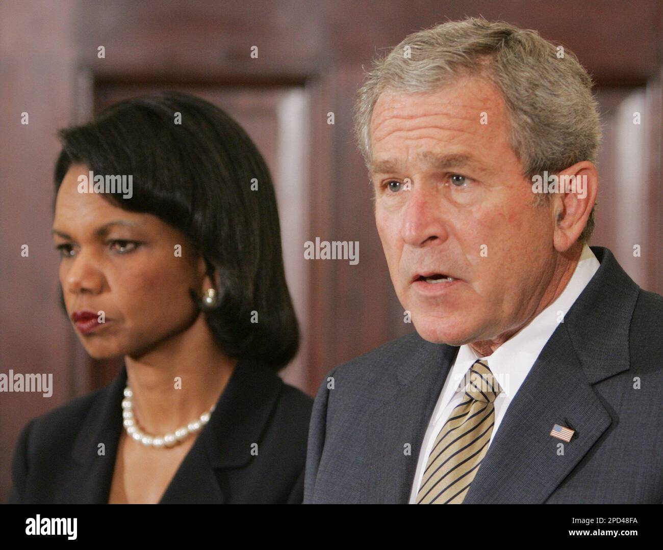 Secretary of State Condoleezza Rice, left, listens as President Bush ...