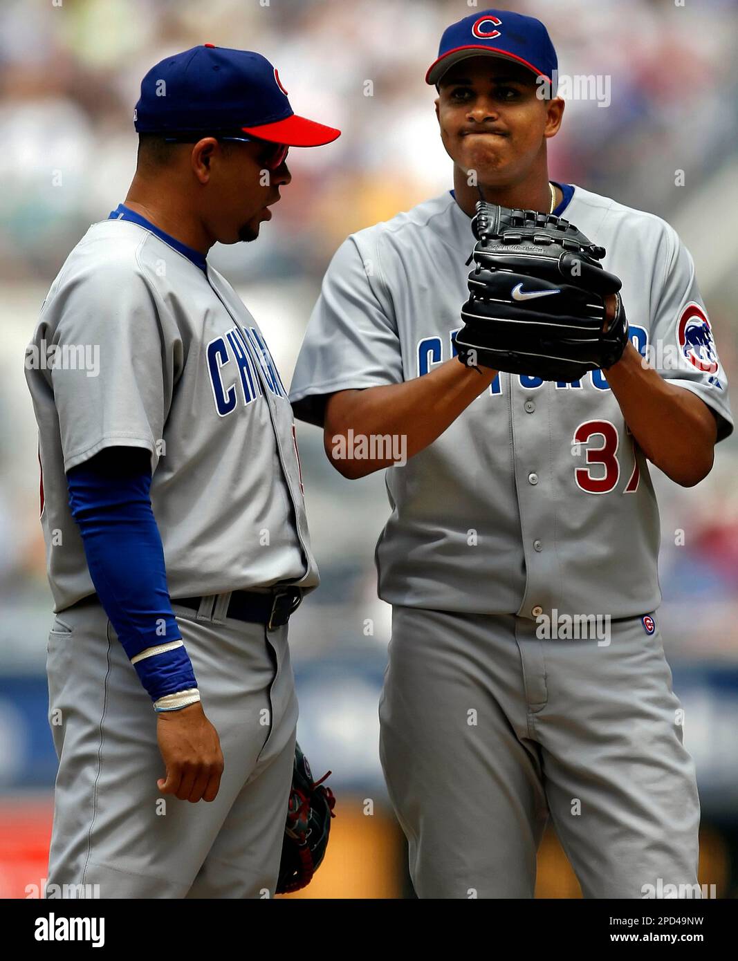 Chicago Cubs starting pitcher Angel Guzman, right, talks with Cubs ...