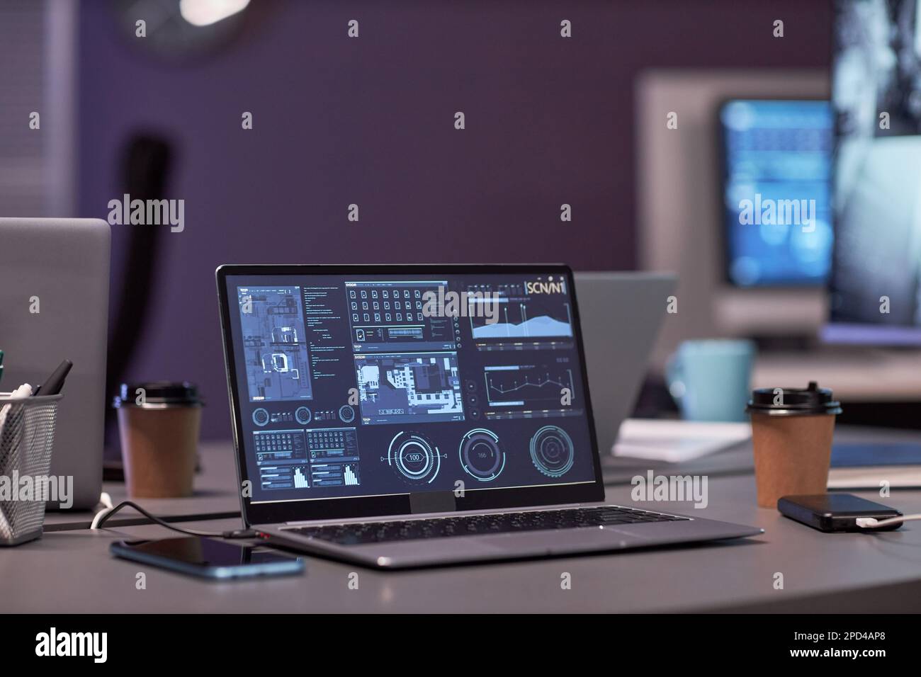 Background image of laptop with data on screen in high tech office ...