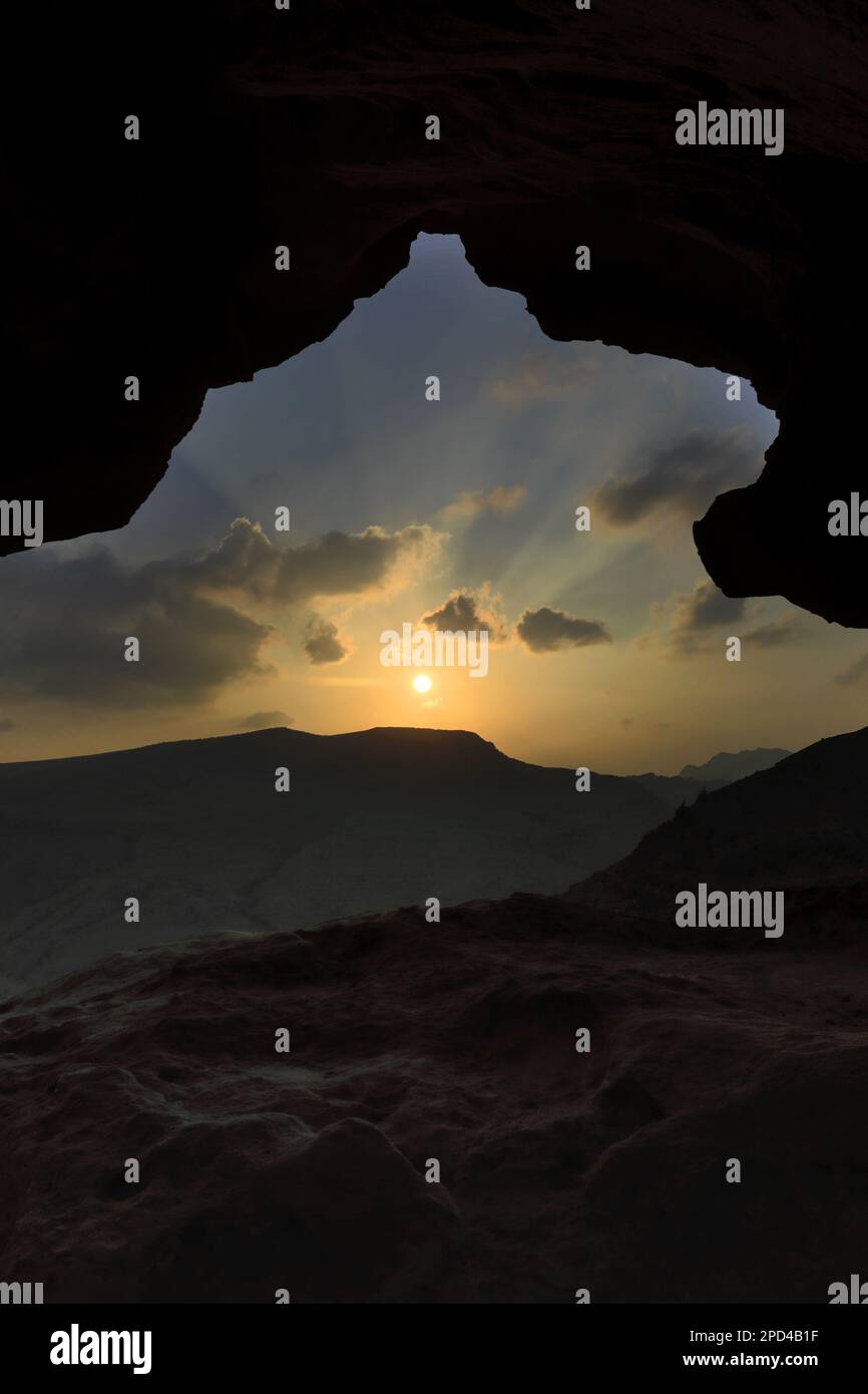 Sunset view through a stone arch at Reis al Fied, Wadi Feid, Jordan ...