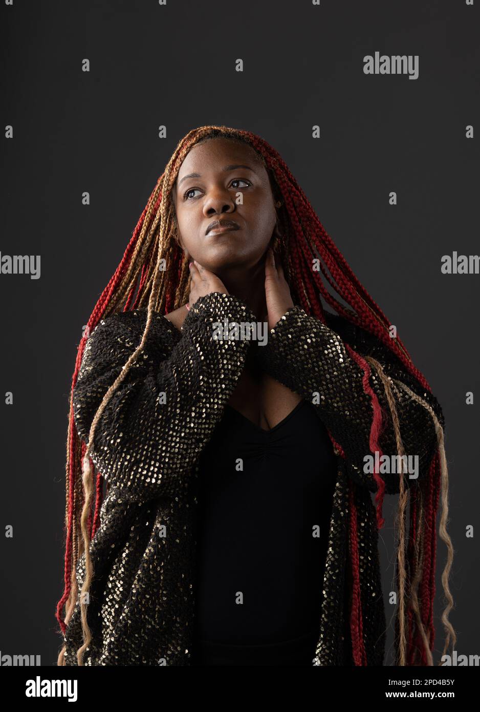 A portrait of a young African American female with red braids against a ...