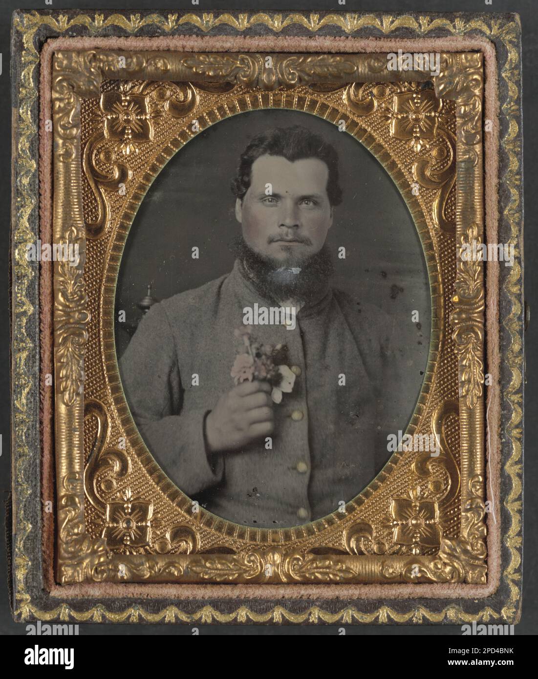 Unidentified soldier in Confederate uniform with bouquet of flowers ...