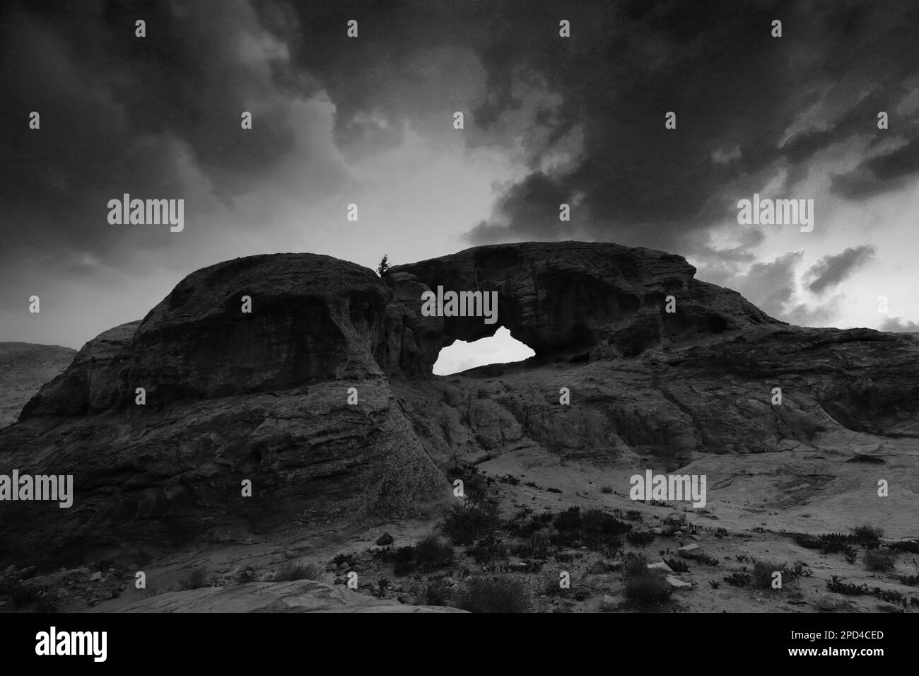 Sunset view through a stone arch at Reis al Fied, Wadi Feid, Jordan ...