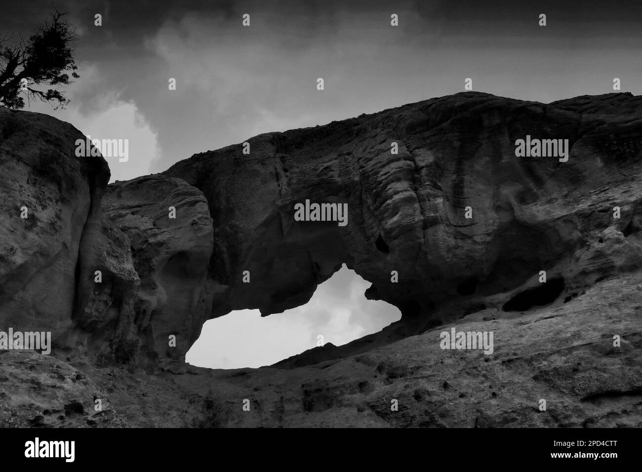 Sunset view through a stone arch at Reis al Fied, Wadi Feid, Jordan ...