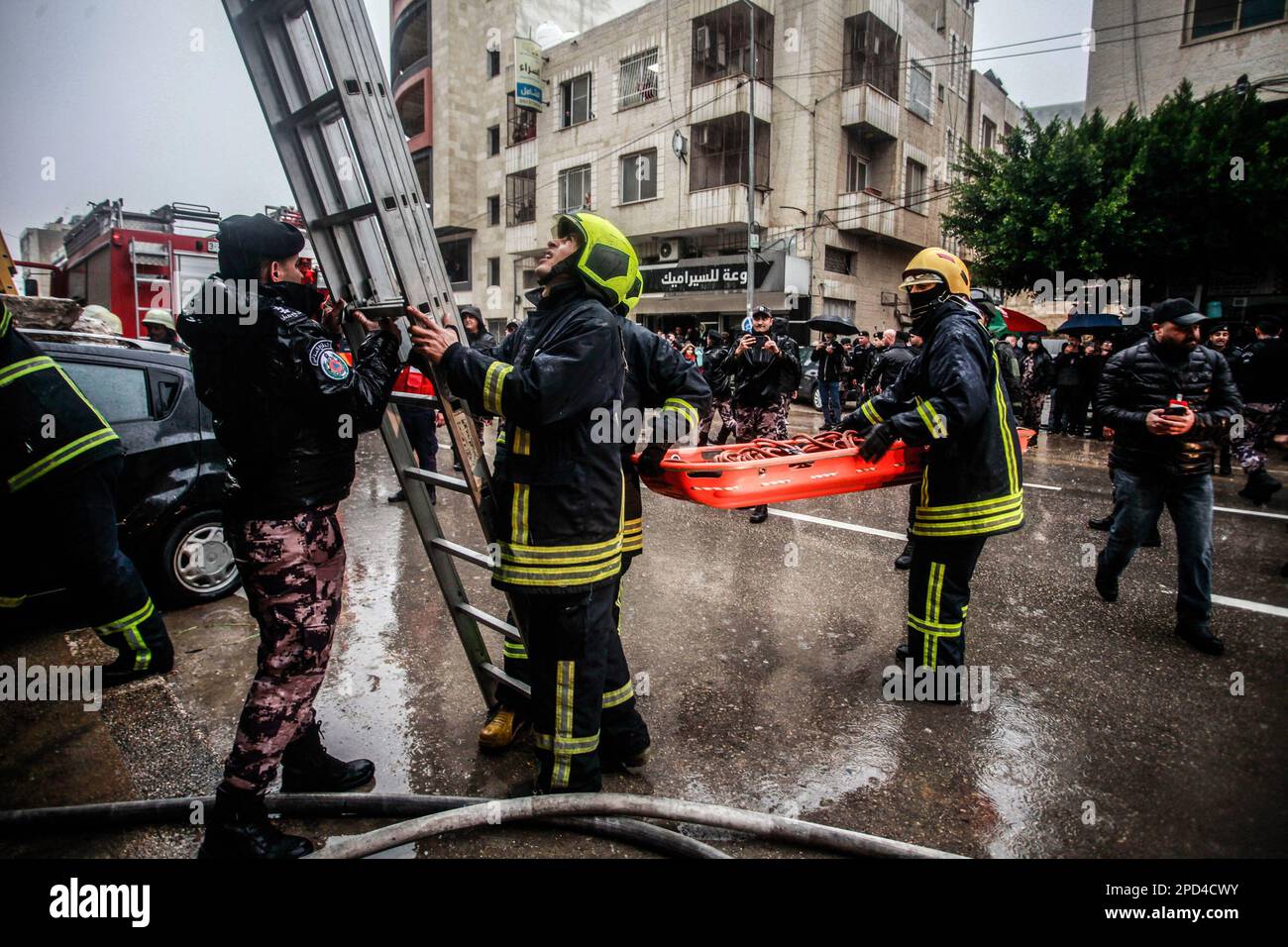Nablus, Palestine. 14th Mar, 2023. Civil defense officers rescue an ...