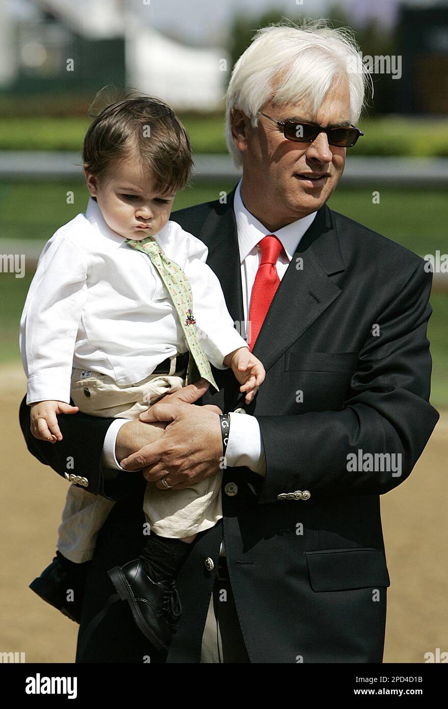 Trainer Bob Baffert carries his son Bode while walking the track at ...