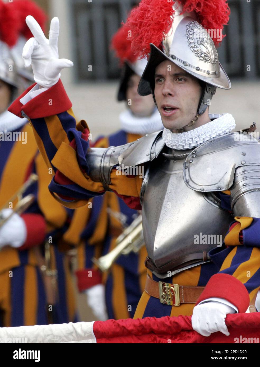 One of the 33 newest members of the Swiss Guards, at right, shows three ...