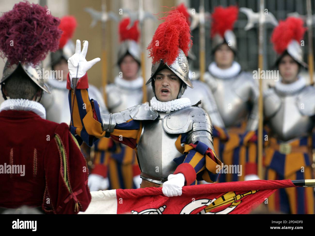 One of the 33 newest members of the Swiss Guards, at right, shows three ...