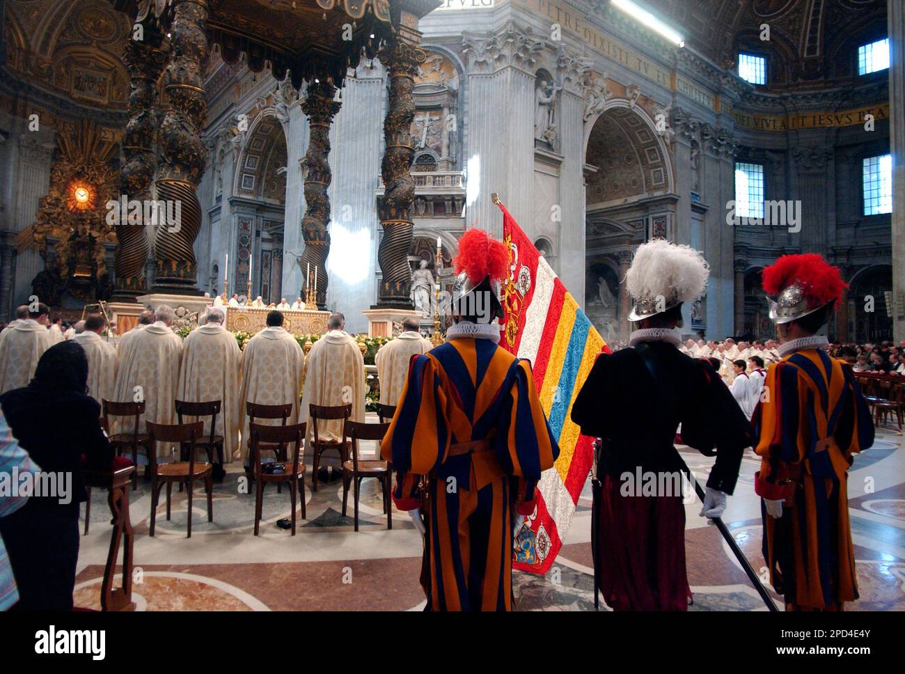 Members of the Swiss Guards corps hold up the papal flag as Pope ...