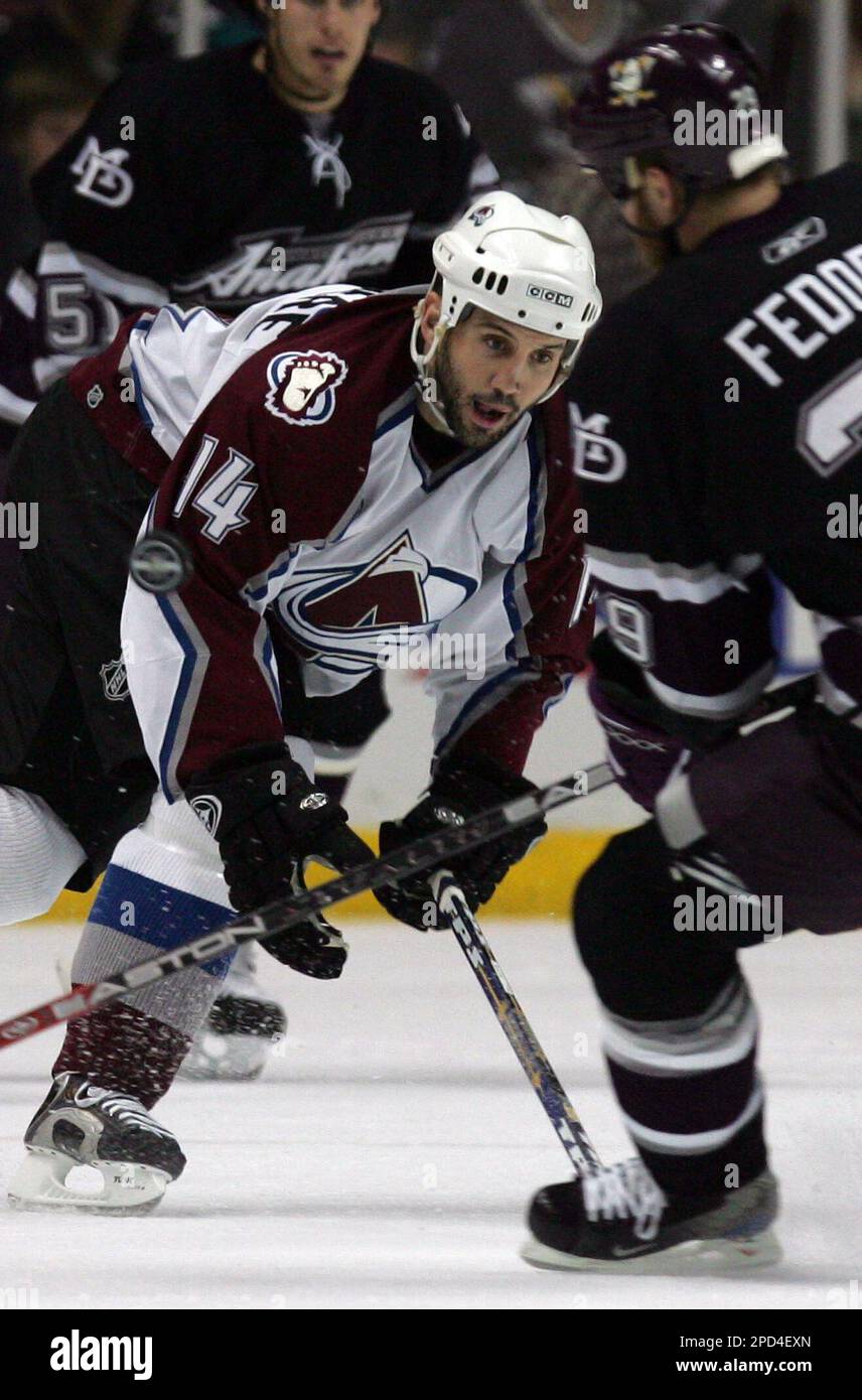 Colorado Avalanche's Ian Laperriere shoots around Anaheim Mighty Ducks ...