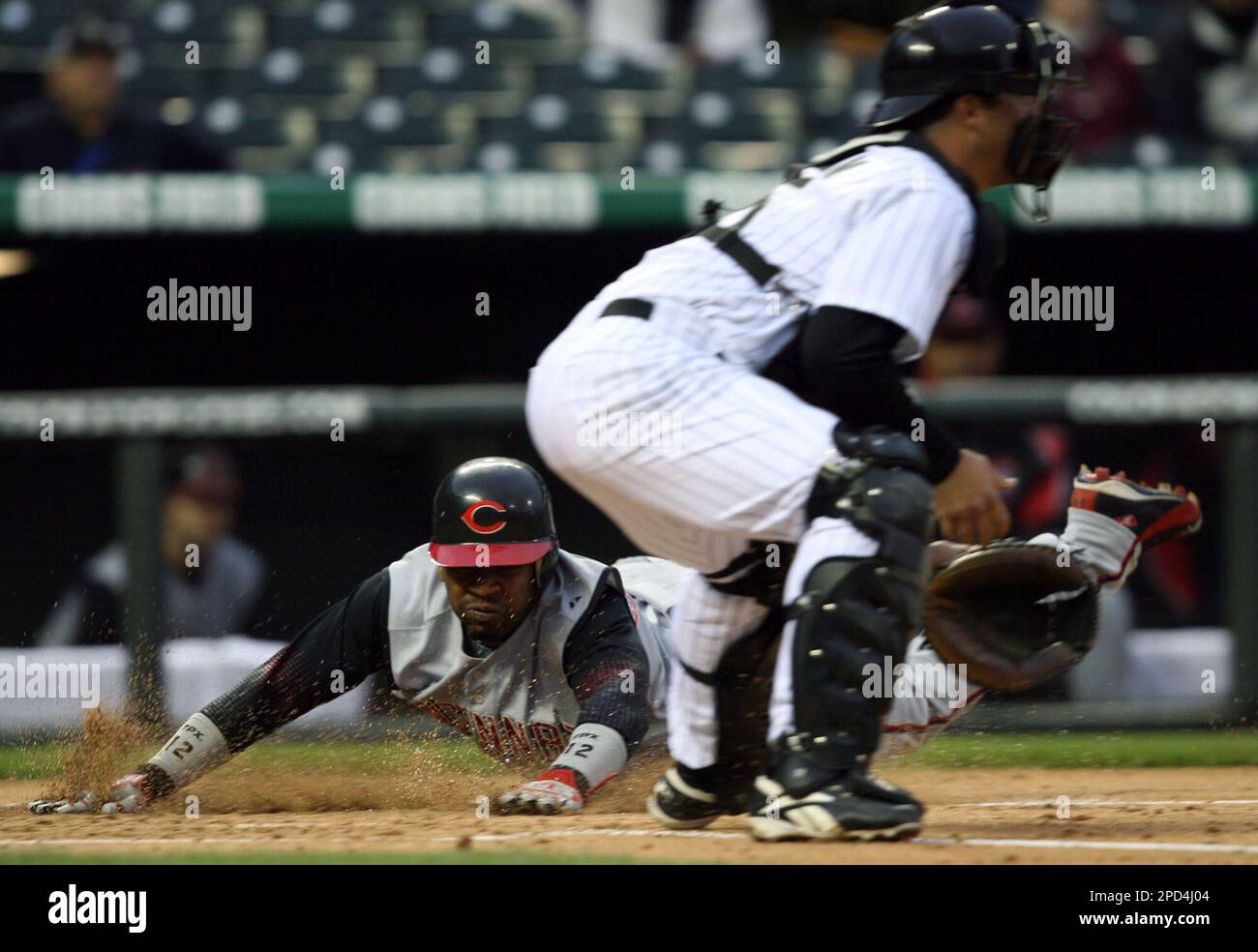 Cincinnati Reds' Edwin Encarnacion, back, slides safely across home ...