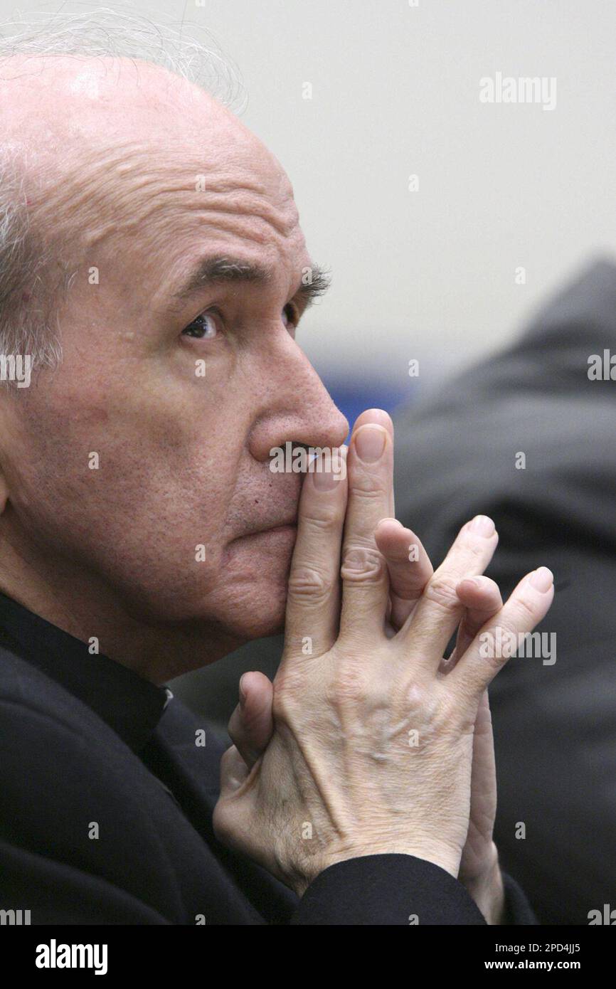 The Rev. Gerald Robinson listens to a tape of an interview he did with ...