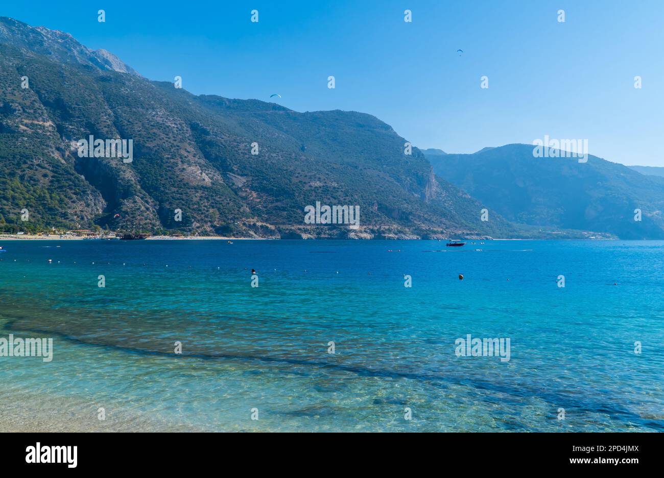 A stunning view of a magnificent body of azure blue water situated near ...