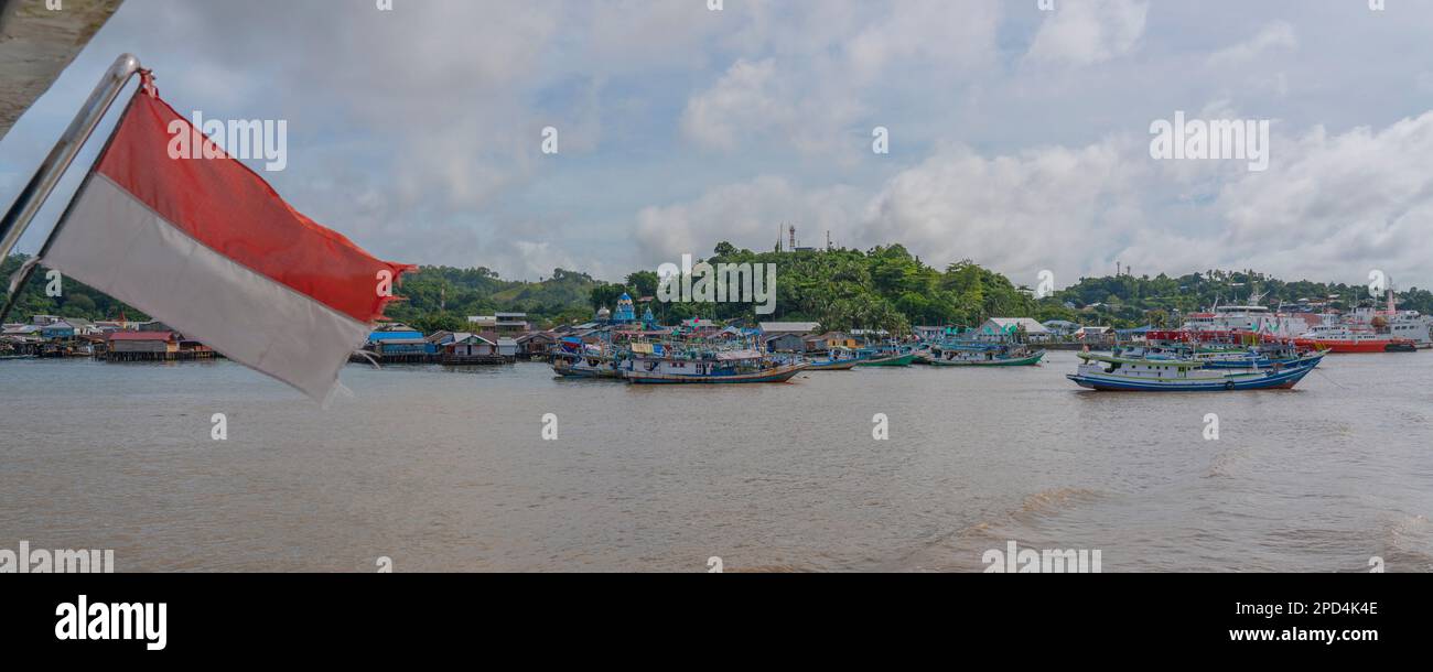 View from the ferry to Waisai in Sorong with the flag of Indonesia ...