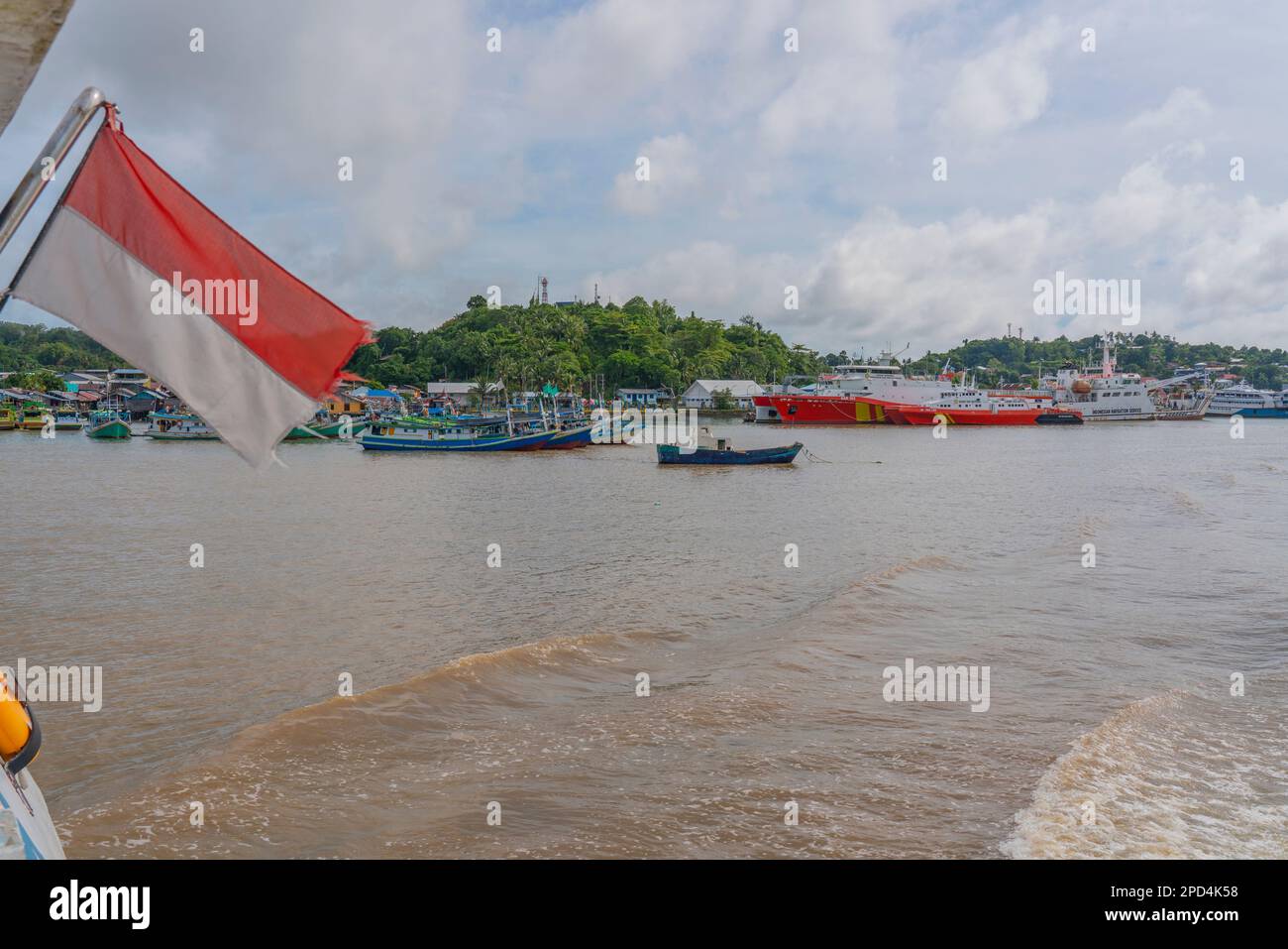 View from the ferry to Waisai in Sorong with the flag of Indonesia ...