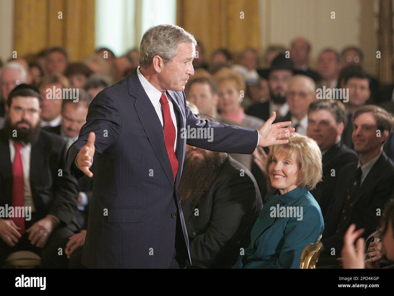 President Bush extends out his arms as he thanks those in attendance ...
