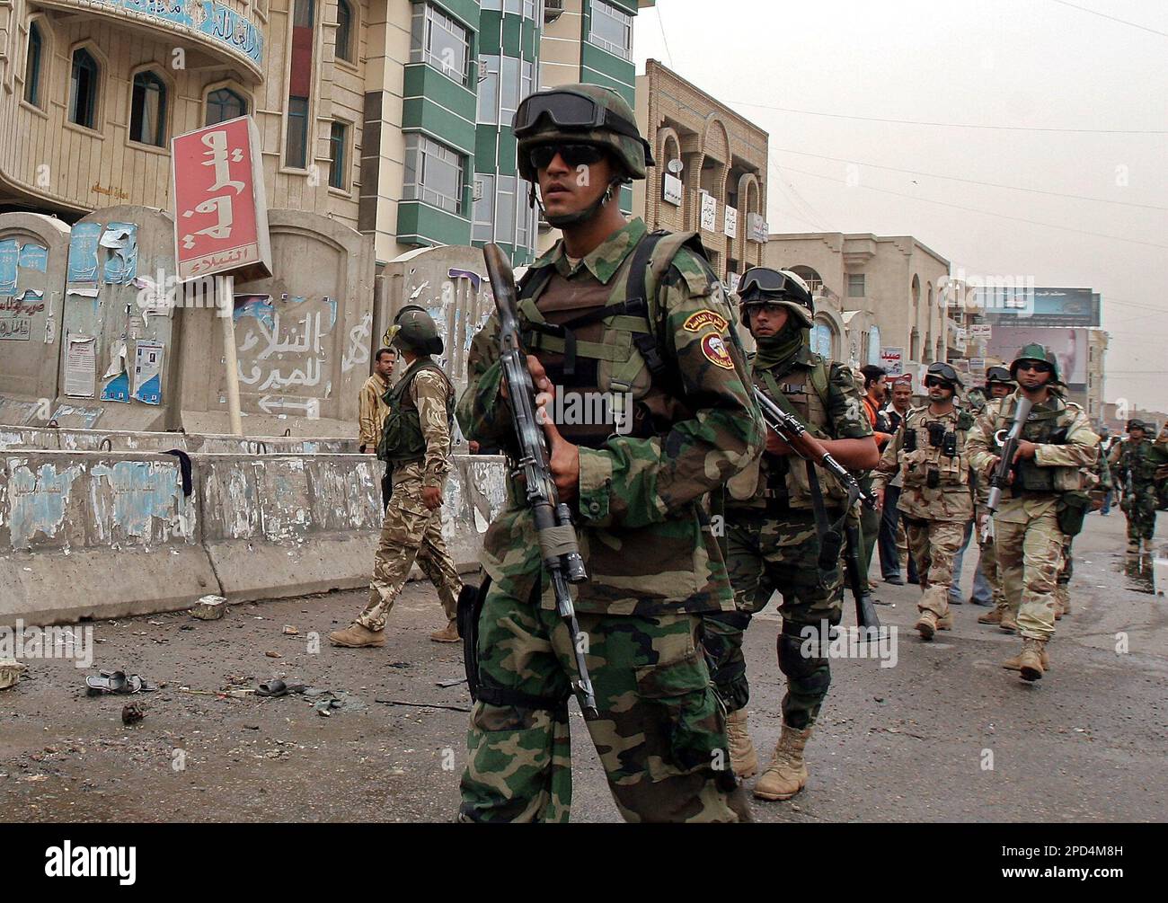 Iraqi soldiers secure the scene following an explosion in central ...