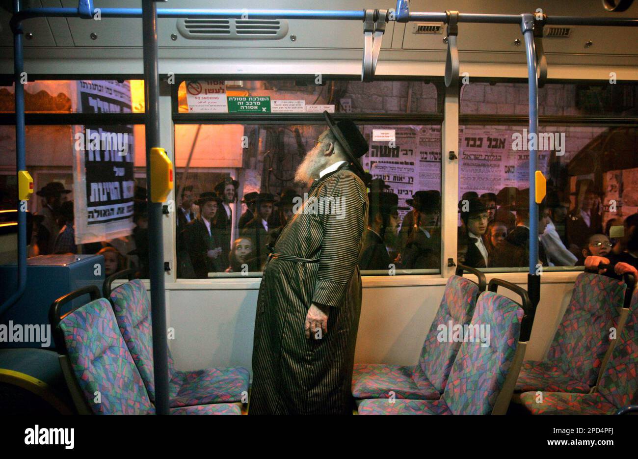 An Ultra-Orthodox Jewish man looks out from a bus to anti-Zionist Ultra ...