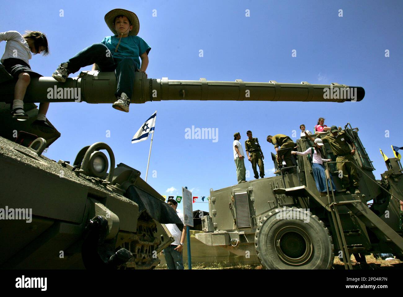 Israeli children climb on the turret of an Israeli Army tank on display ...