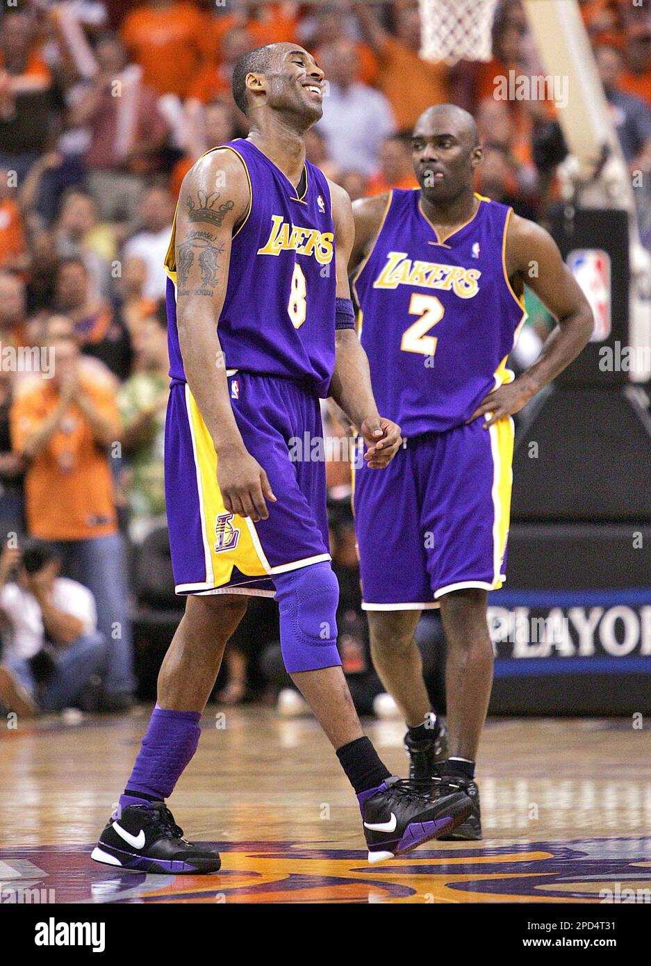 Los Angeles Lakers' Kobe Bryant, left, walks off the court after being ...
