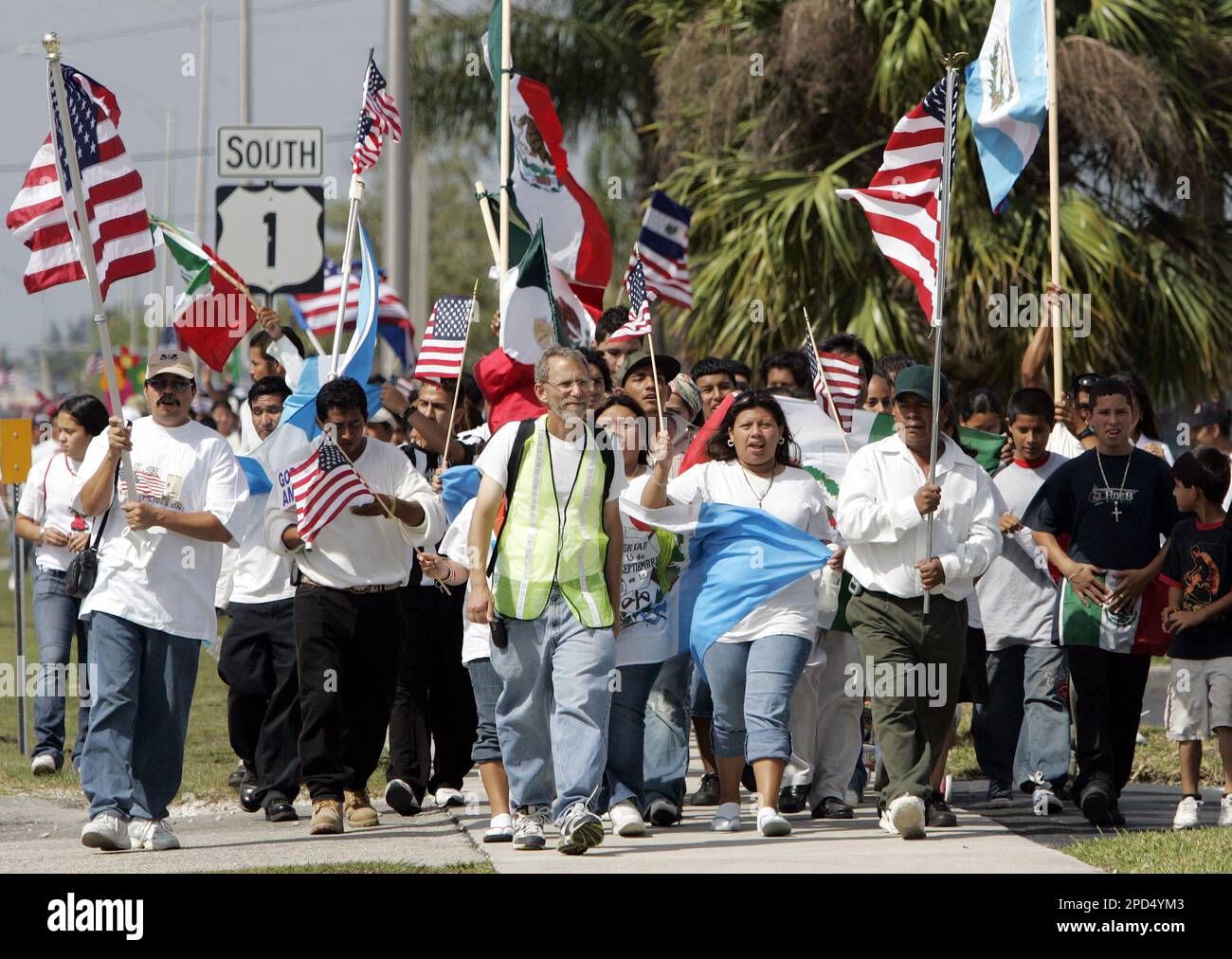 Protestors carry American, Mexican and Guatemalan flags as thousands ...