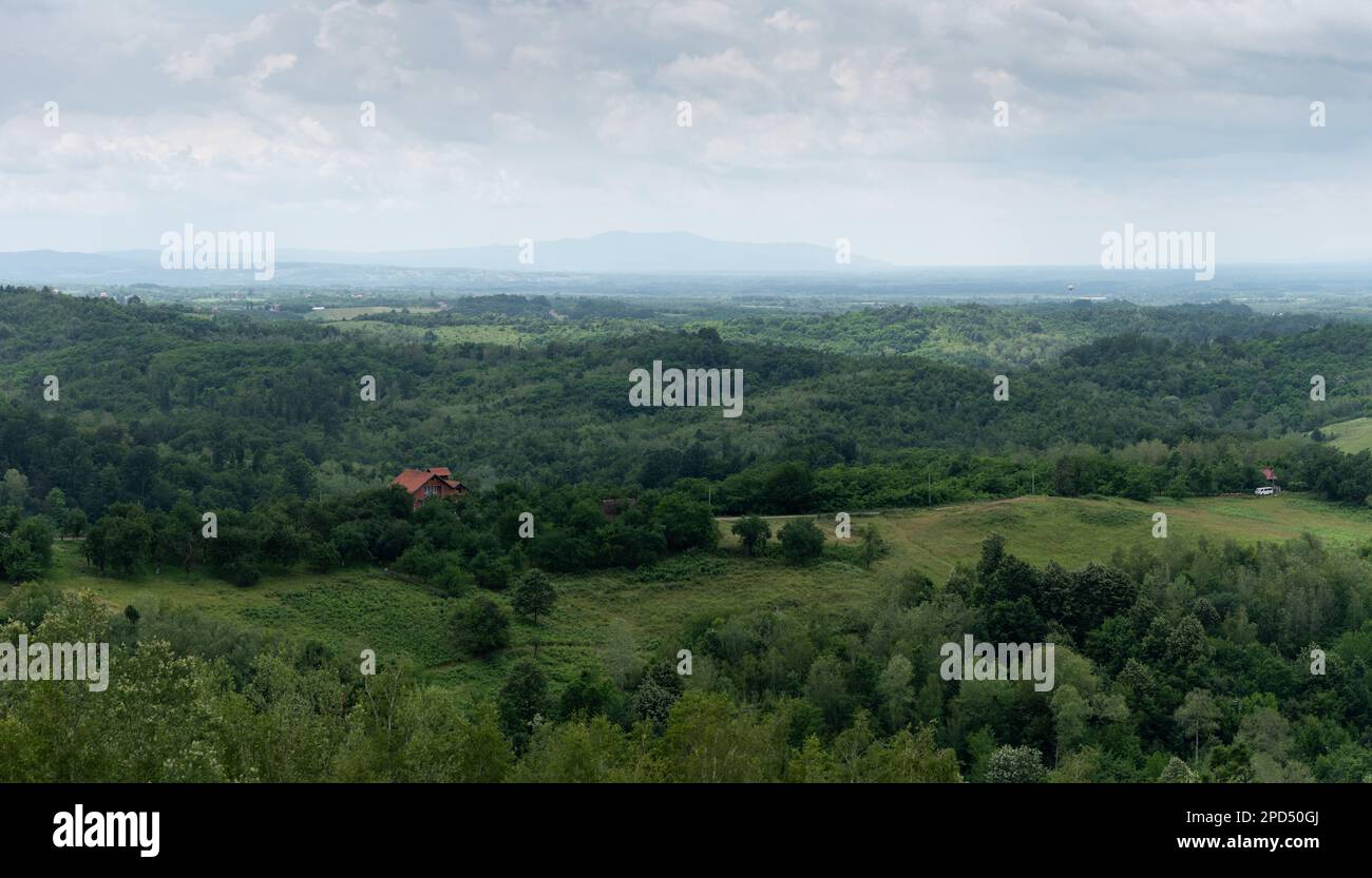 Countryside hilly landscape with villages during cloudy day, lush ...
