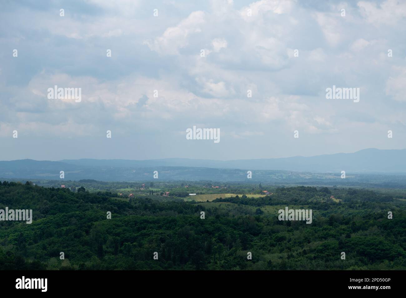 Sun spot on landscape against hill layers in mist, hilly landscape with ...