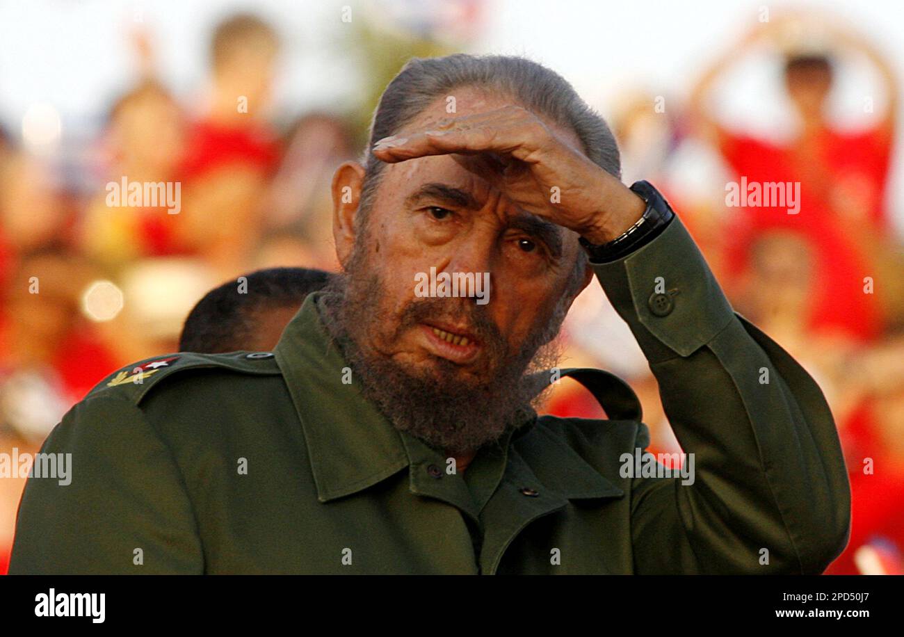 Cuba's President Fidel Castro looks to thousands of people gathered ...
