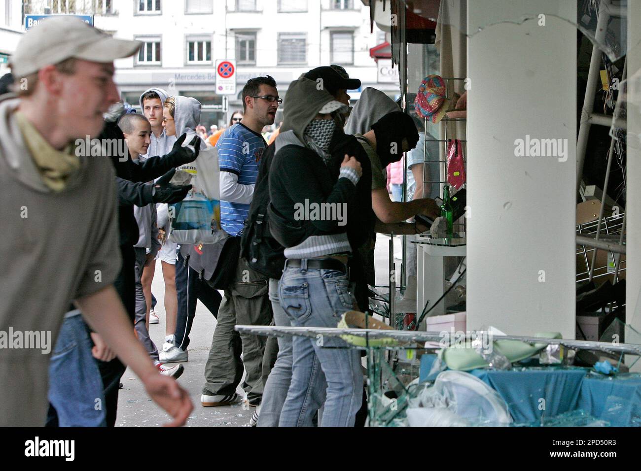 Masked demonstrators loot a shop, after the official traditionnal May ...