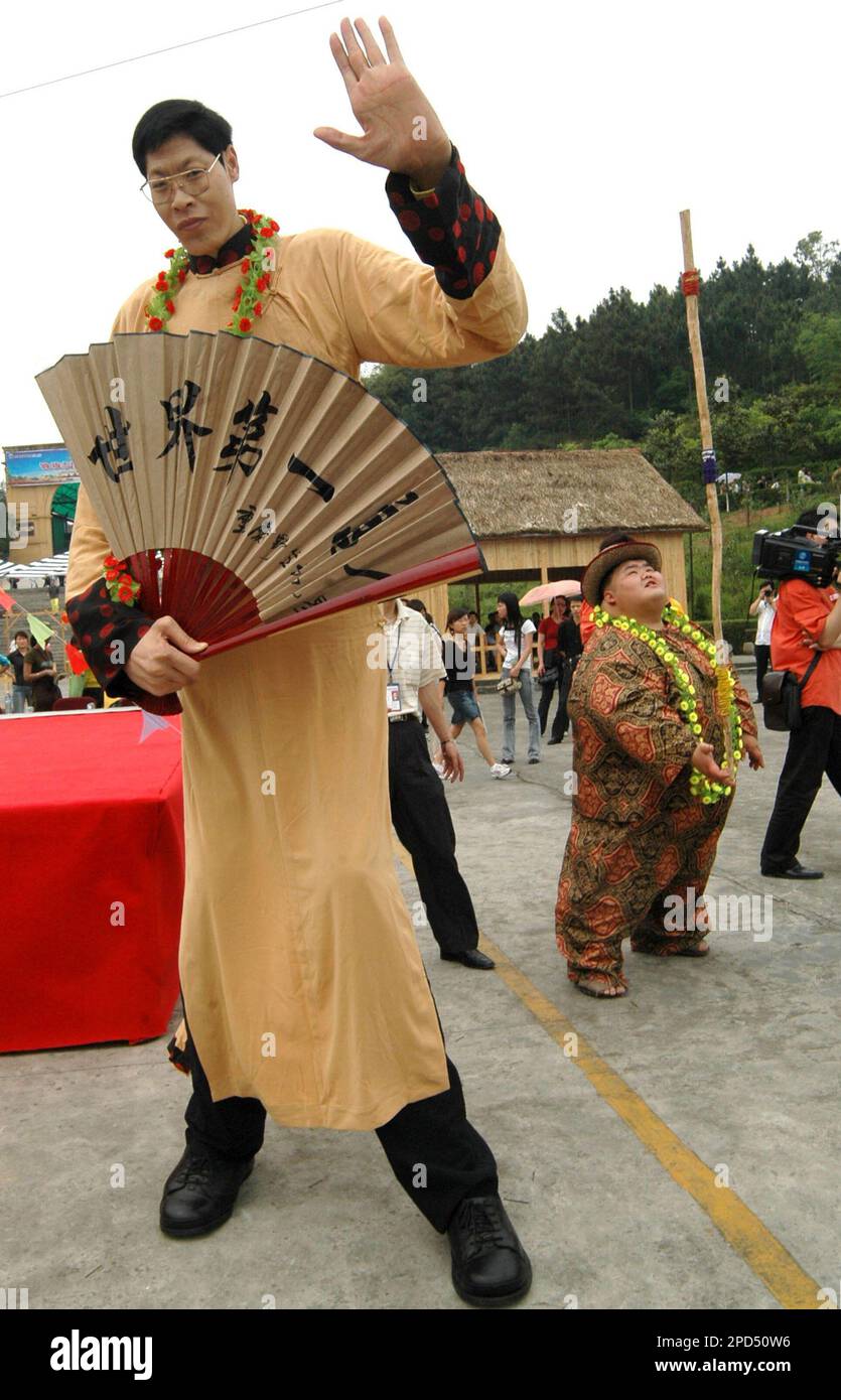 Zhang Juncai, at 2.42-meter-tall, left, billed as the world's tallest ...