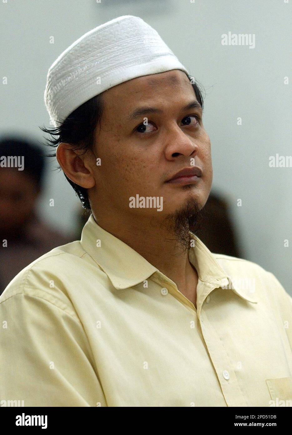 Islamic militant Abdulah Sunata sits on the defendant's chair during ...